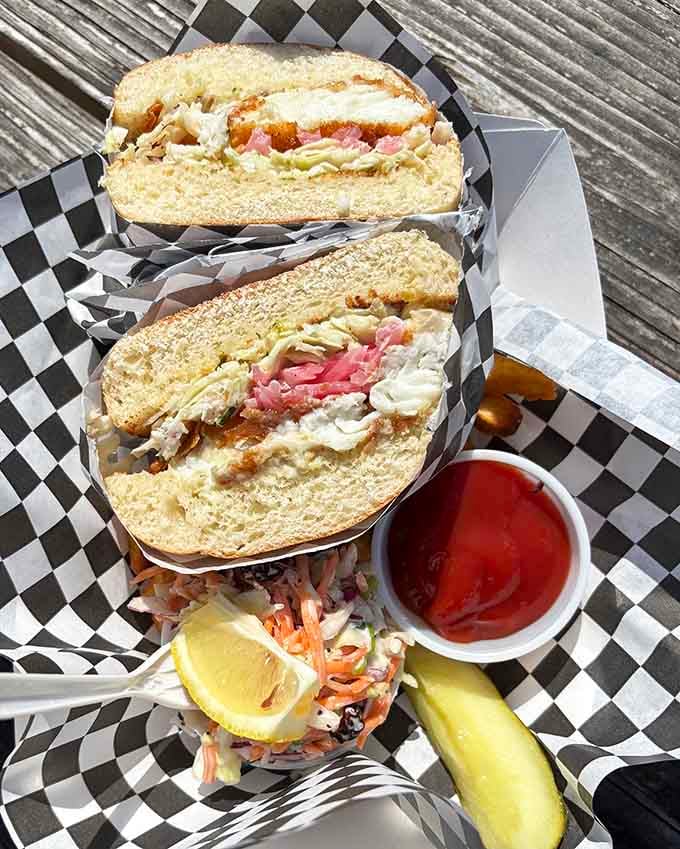 That brioche bun is working overtime, holding together layers of perfectly fried fish and all the fixings.