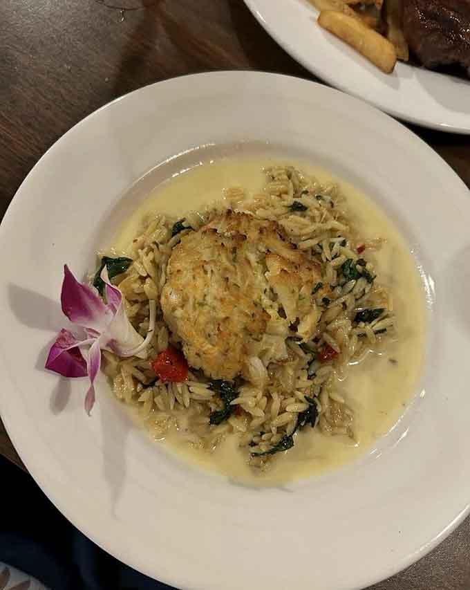 Crab cake over orzo with a purple orchid garnish, fancy enough to impress without requiring a second mortgage.