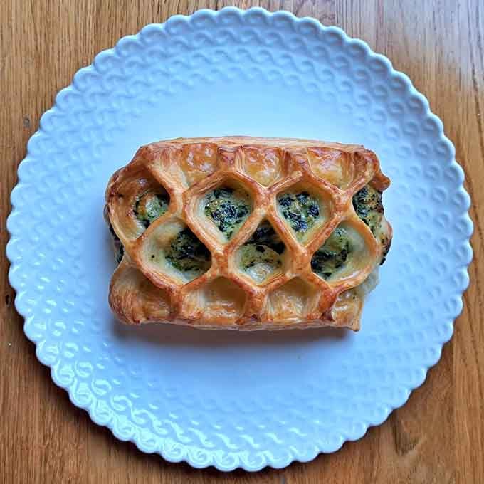 That lattice-topped pastry filled with spinach and cheese is what happens when breakfast gets fancy without being pretentious.