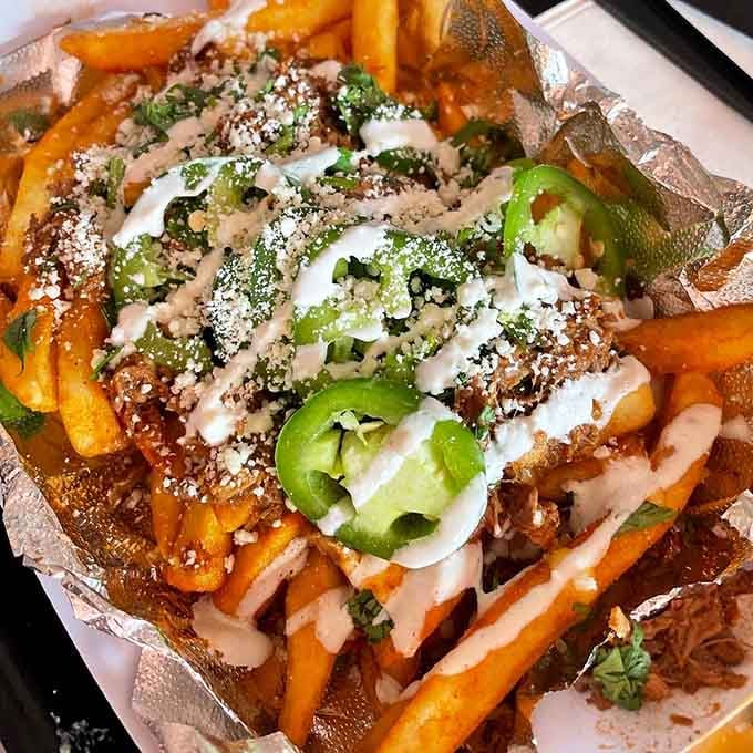 Loaded birria fries topped with crema, cheese, and jalape&ntilde;os are basically a fiesta on a plate.