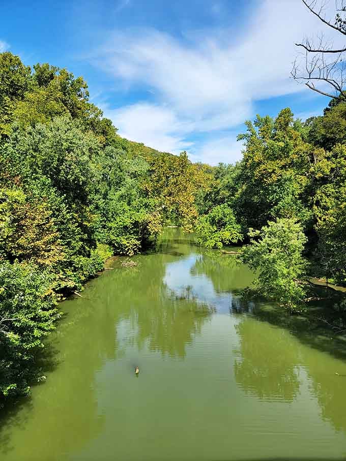 Peaceful waters flow where ferry boats once delivered eager visitors to their weekend paradise in the woods.