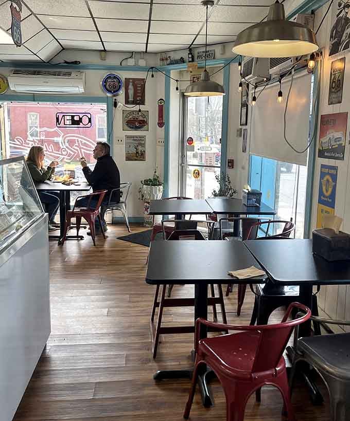 Sunlight streams through windows while diners tackle burgers that require both hands and possibly a game plan to finish.