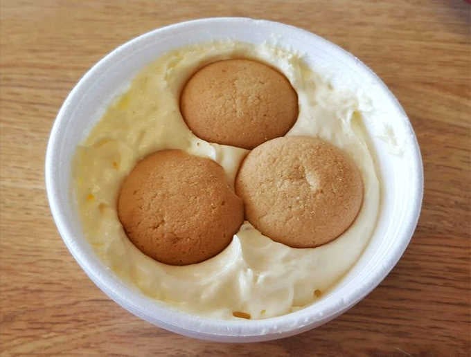 Three golden orbs of banana pudding perfection floating in vanilla clouds, the kind of dessert that makes you order seconds.