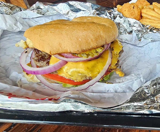 This burger means business with its perfectly melted cheese and fresh toppings wrapped in foil like a delicious present.