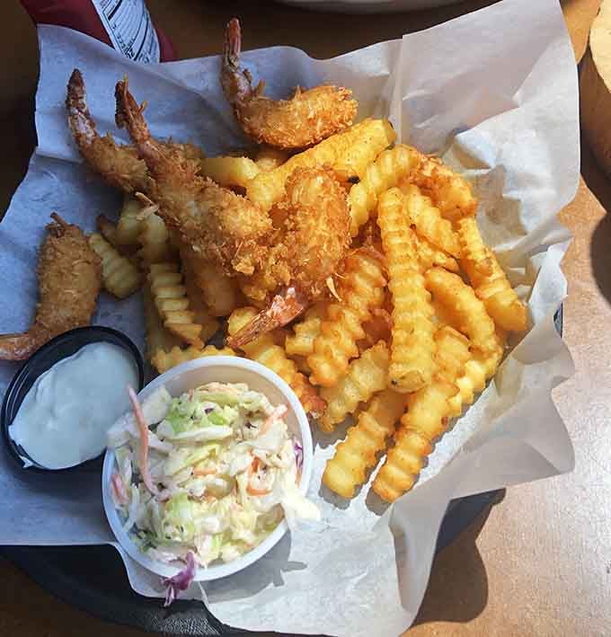 Coconut-crusted shrimp with crinkle-cut fries delivers that satisfying crunch that echoes across the water with every bite you take.