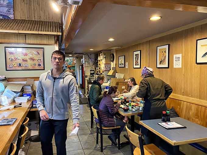 Happy diners enjoying their feast in the warm, bustling atmosphere of Portland's sushi treasure.