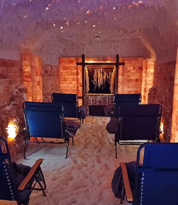 Inside the salt cave, zero-gravity chairs await beneath walls that shimmer like a sunset made of minerals.