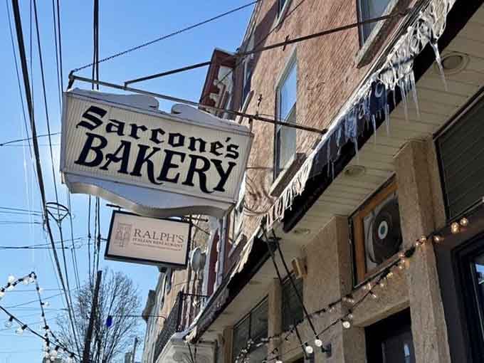 That vintage sign hanging above the street is basically a beacon guiding the faithful to carbohydrate paradise below.