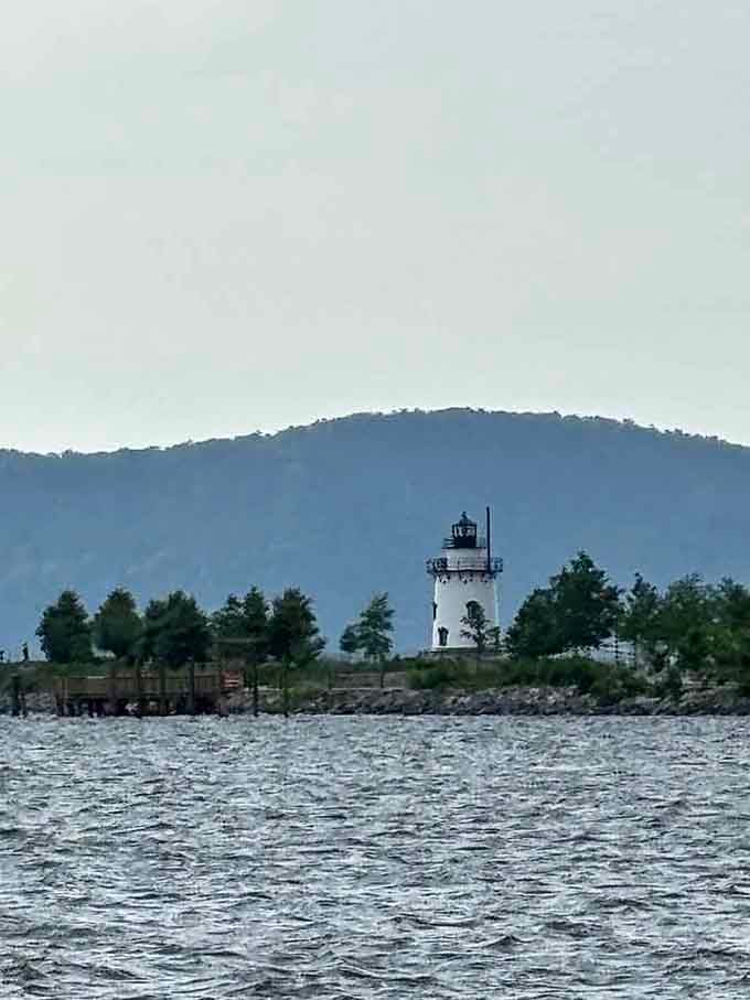 The historic lighthouse stands sentinel over the river, a reminder of the Hudson's maritime heritage and navigational importance.