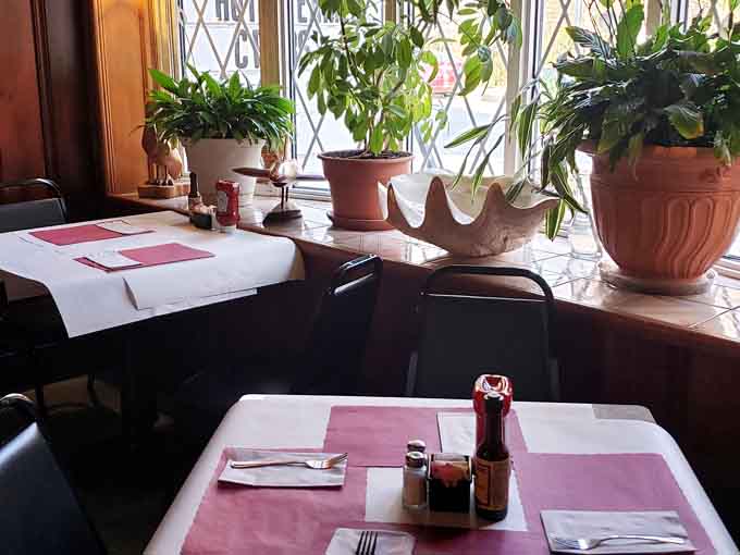 Potted plants in the windows add unexpected charm to this no-nonsense crab house, softening the edges just right.