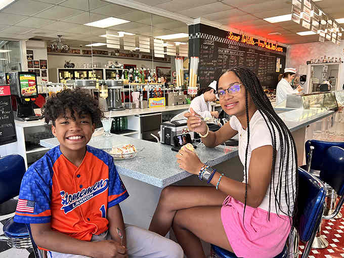 The smiles say it all: this is where memories are made, one scoop at a time, generation after generation.