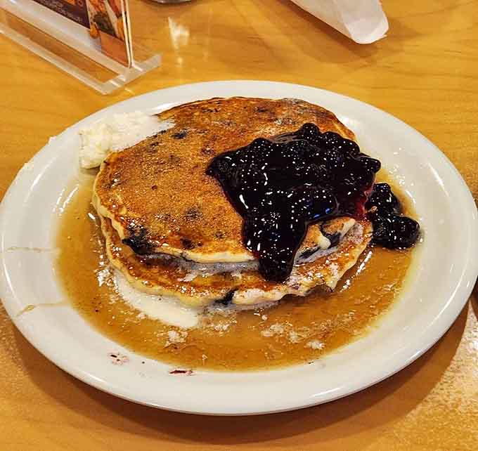 Blueberry pancakes topped with more blueberries, because sometimes enough is never quite enough when it's this delicious.