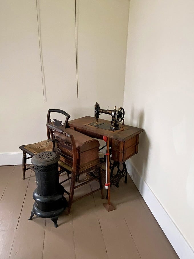 A treadle sewing machine stands ready, testament to the self-sufficiency required when your nearest neighbor is a boat ride away.