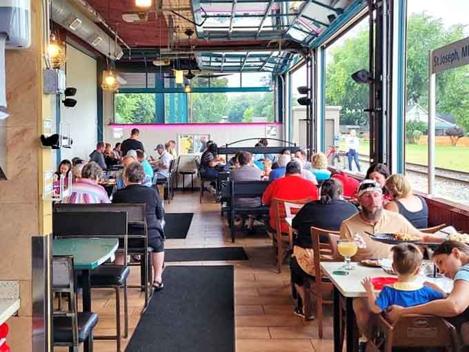 Garage-style doors open to let the lake breeze in while families gather for meals that create lasting summer memories.