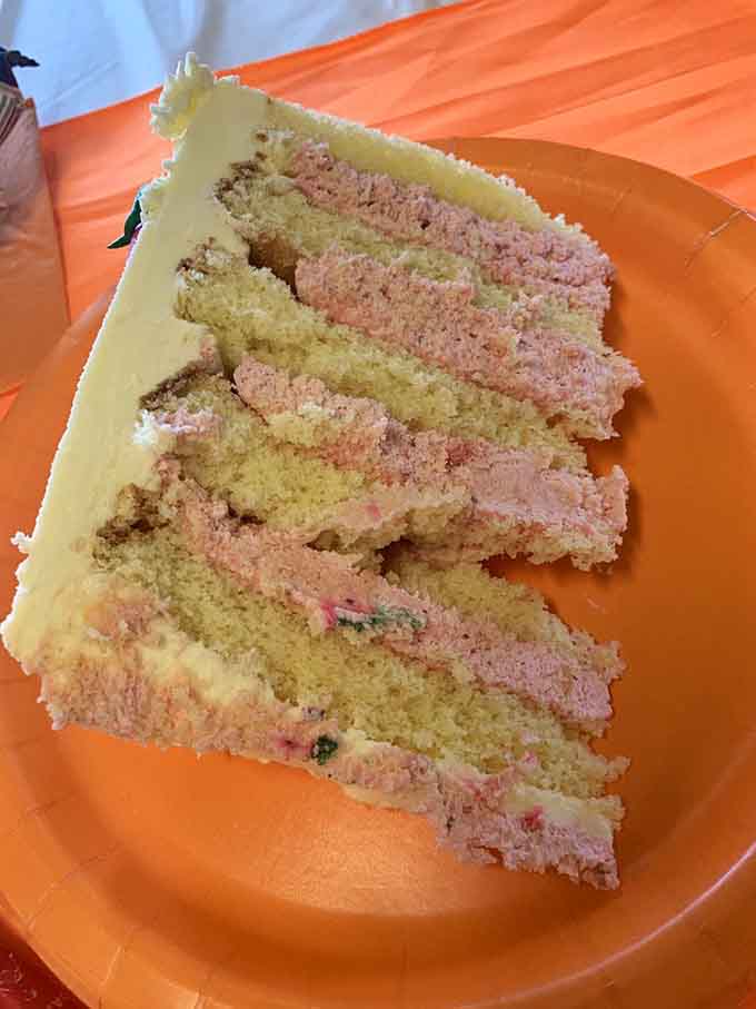 Fluffy layers of raspberry cream cake stacked high enough to require architectural planning and serious willpower.