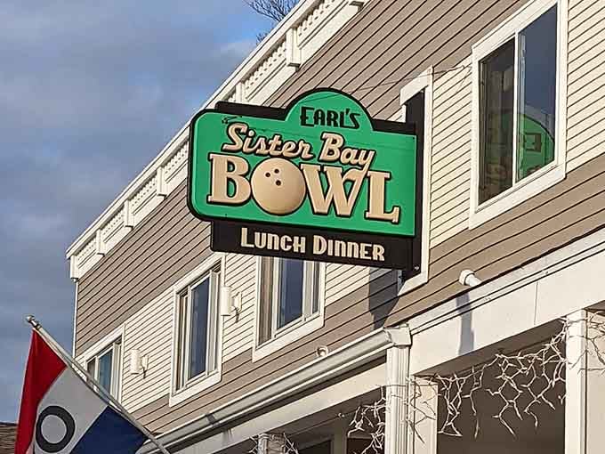 Sister Bay Bowl's vintage sign promises old-school fun, cheese fries, and the satisfying crash of pins hitting hardwood.