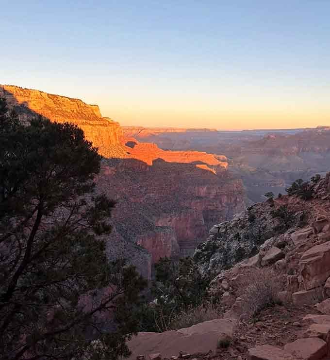 Golden hour transforms the canyon into a masterpiece of light and shadow, painting rocks in impossible shades of amber.