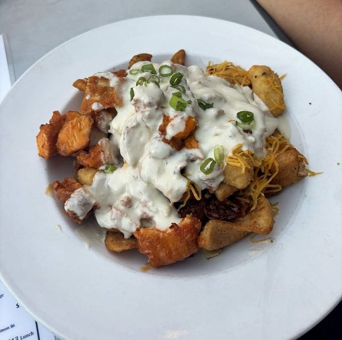 Buffalo chicken poutine smothered in gravy and cheese, because sometimes you need comfort food with your craft beer.