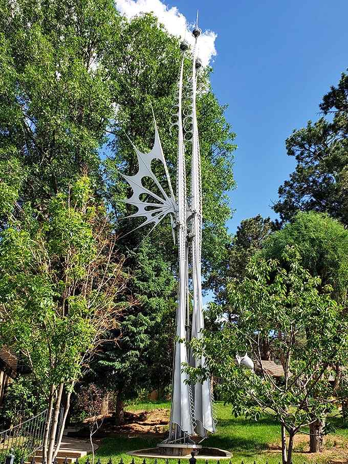 Three towering spires pierce the sky like a futuristic cathedral, their elegant lines creating poetry in polished metal and air.