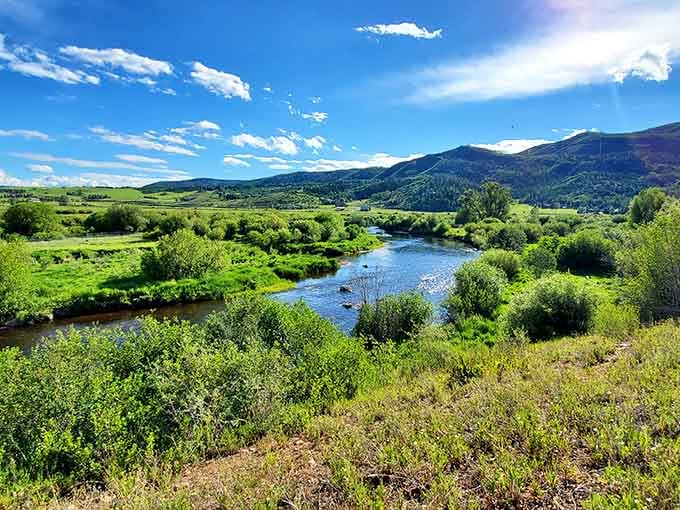 The Yampa River winds through green valleys where your biggest decision is walking, biking, or just staring.