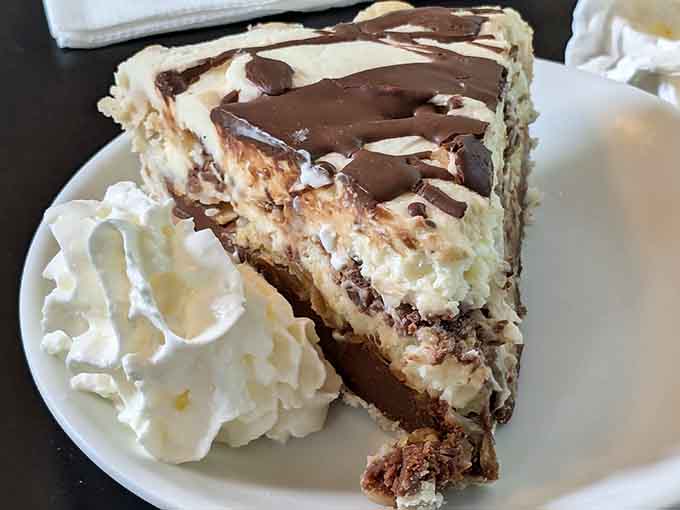 Peanut butter pie layered with chocolate and crowned with whipped cream, because sometimes dessert should be completely over the top.