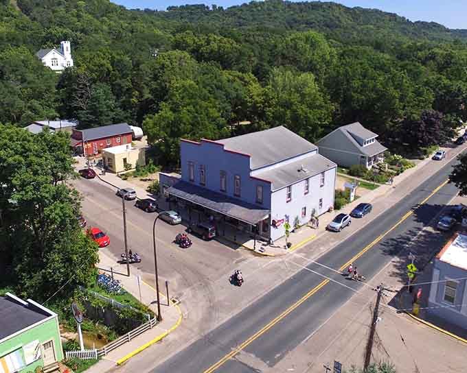 Bluffs embrace the tiny downtown like protective arms, creating a valley where time moves at its own leisurely rhythm.
