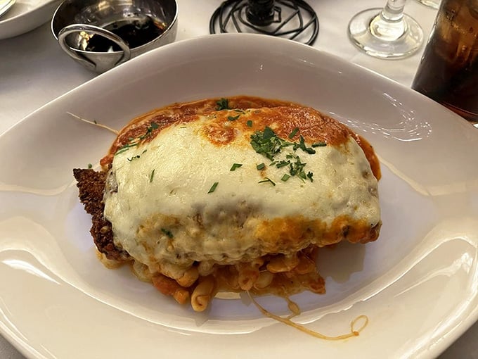 Chicken parm so generously topped with melted cheese it practically demands you loosen your belt before the first bite.