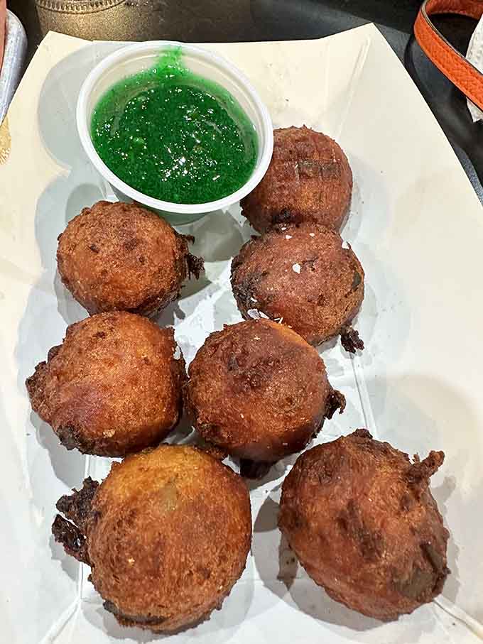Those golden pork belly hush puppies with the bright green sauce are basically the opening act that steals the show.