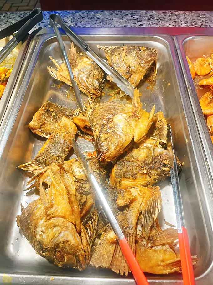 Whole fried fish with crispy fins that crunch like potato chips, making your inner food adventurer very happy.