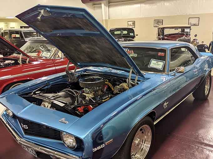 That Camaro's engine bay is cleaner than most people's kitchens, showcasing muscle car power in all its glory.