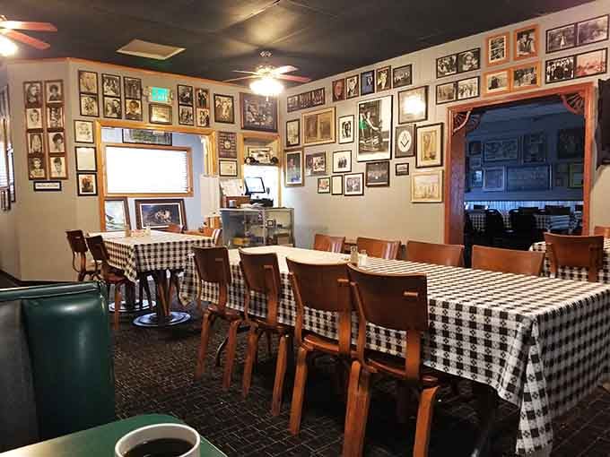 The checkered tablecloths and vintage photographs create an atmosphere that feels like Sunday dinner at your favorite aunt's house.