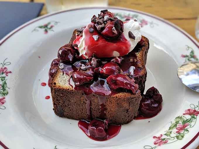 Buckwheat cake topped with cherries and cream is the kind of dessert that makes you forget you were supposed to be full.