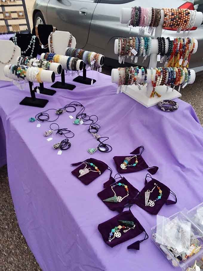 Handcrafted beaded jewelry displayed on purple velvet like tiny works of art waiting for their forever wrists.