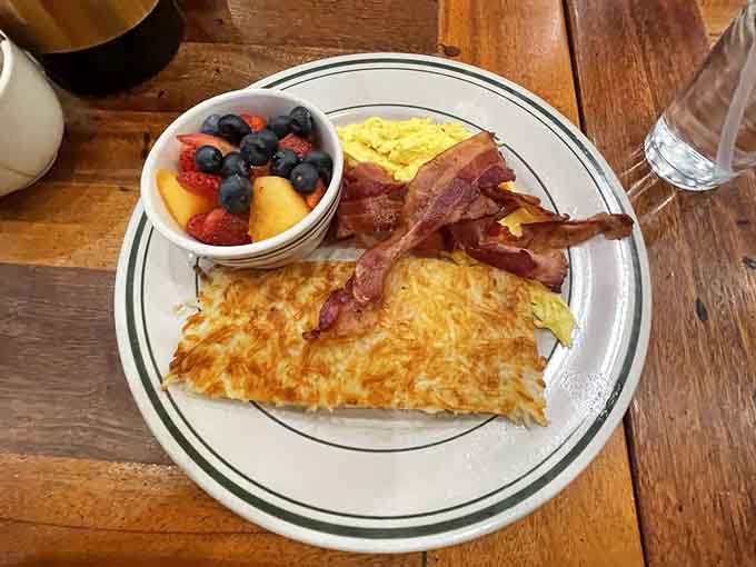 Hash browns so golden and crispy they could moonlight as edible treasure, paired with bacon and scrambled perfection.