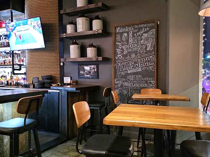 Rustic wooden shelves and cozy seating create that perfect barbecue joint vibe where everyone feels right at home.