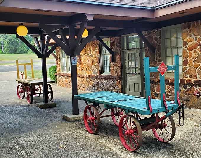 Colorful baggage carts add whimsical charm to the platform, looking like props from a delightful period film.