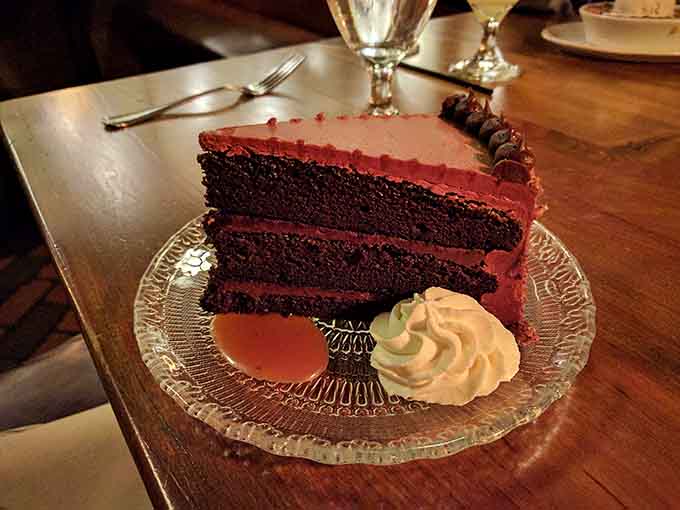 Chocolate cake towering like a delicious skyscraper, proving dessert is always worth saving room for somehow.