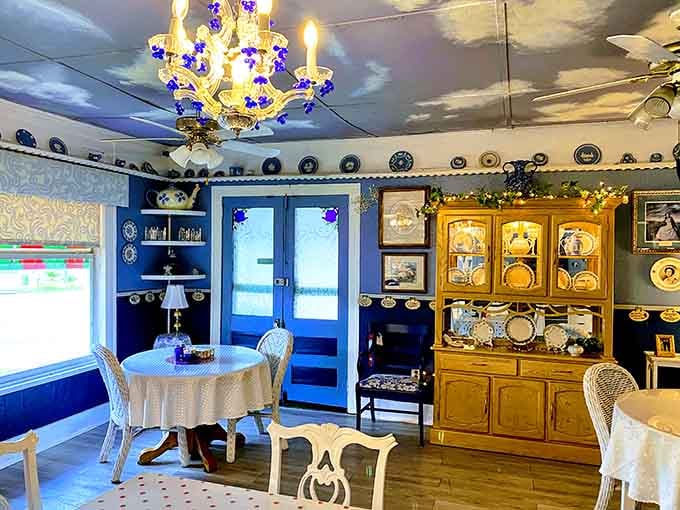 That chandelier and endless plate collection create a dining room vibe somewhere between antique shop and someone's beloved great-aunt's parlor.