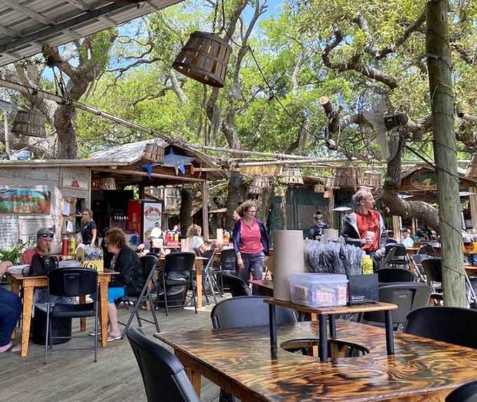 Outdoor dining under the oaks where the dress code is "comfortable" and the vibe is pure coastal bliss.