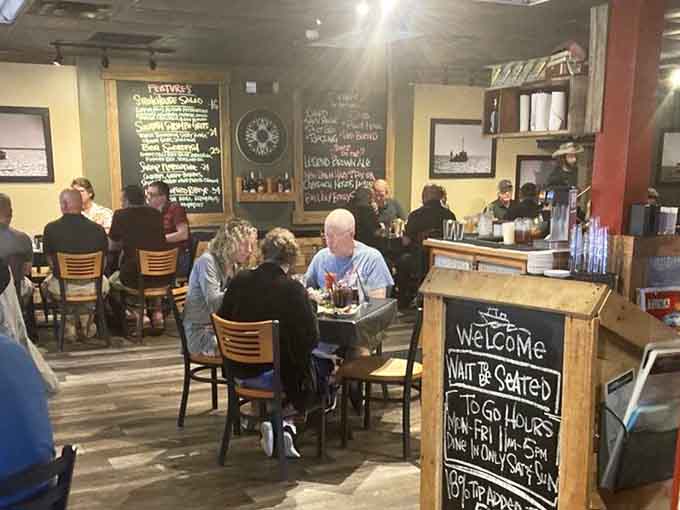 Diners settle in at wooden tables where chalkboard specials and maritime decor set the scene for memorable waterfront meals.