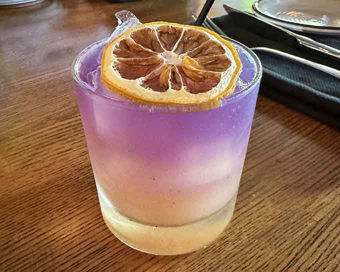 This purple-hued cocktail with dried citrus looks like sunset decided to become drinkable and utterly Instagram-worthy.