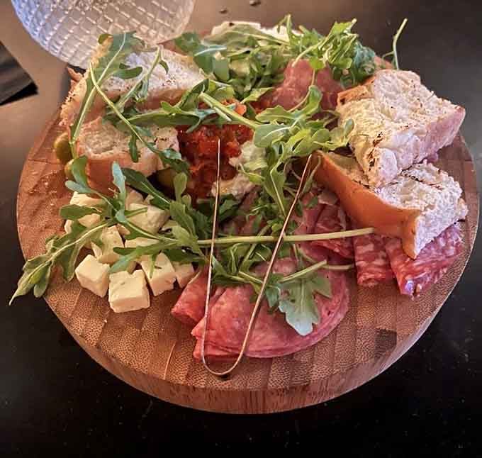 A charcuterie board that transforms cured meats and cheese into an edible work of art worth photographing extensively.