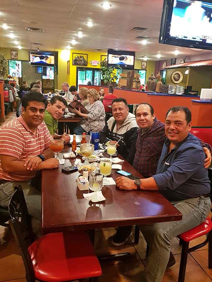 Happy diners gathered around good food and cold drinks, because The Ketch knows how to bring people together beautifully.