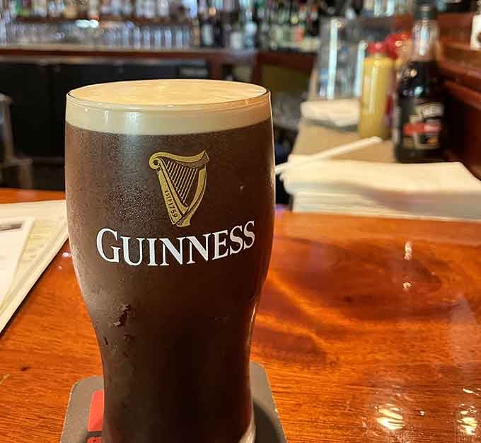 A perfectly poured Guinness with that iconic harp logo, because some traditions are worth maintaining with precision.