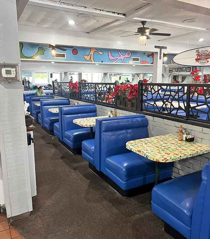 The surfboard hanging overhead has probably seen less action than these booths during weekend breakfast rush.