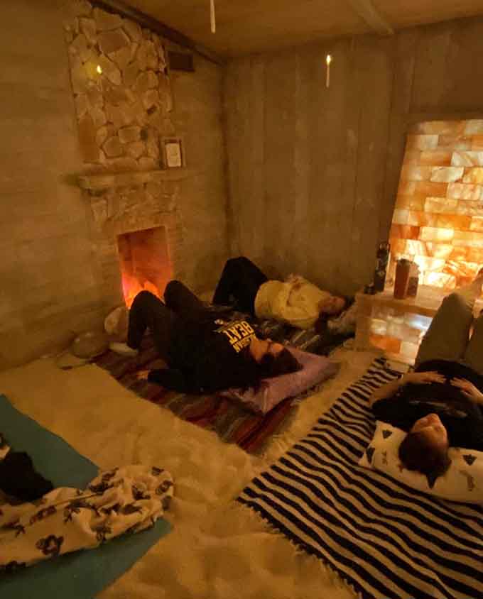 That family sprawled out on blankets shows how salt therapy brings generations together for shared moments of pure, peaceful bliss.