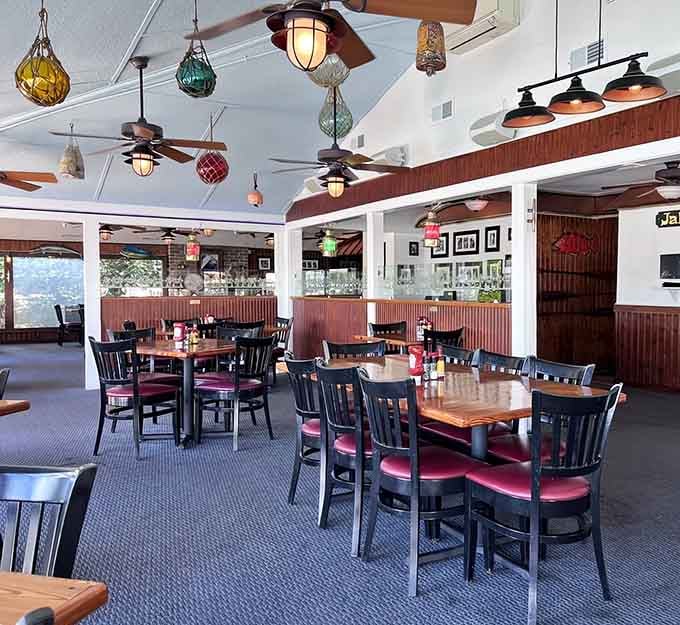 Dining room with nautical charm where ceiling fans keep things cool and the vibe stays perpetually vacation-ready.