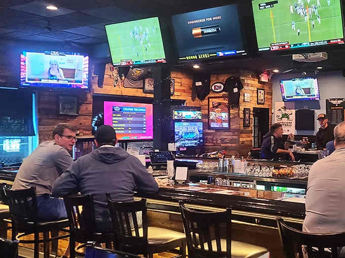 Flat screens surround the bar where locals gather to debate plays and devour burgers bigger than their heads.