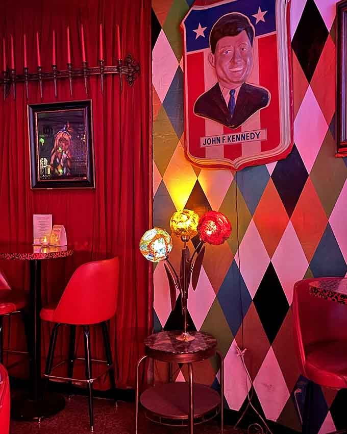 JFK watches over this cozy corner booth, because nothing says Cold War nostalgia quite like mid-century presidential decor done right.