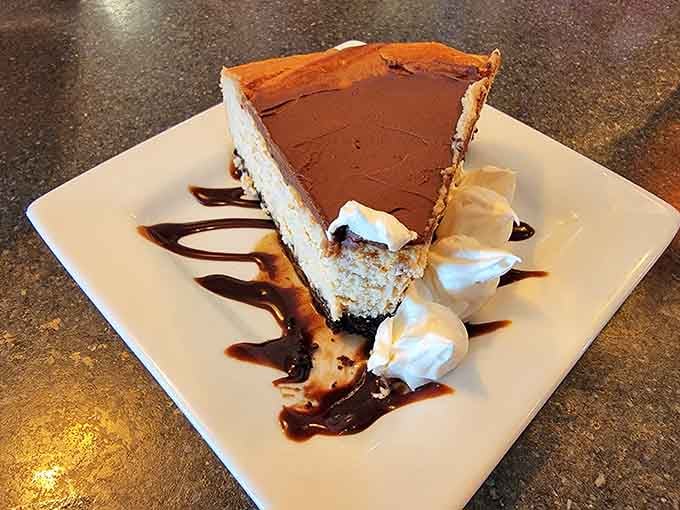 Cheesecake drizzled with chocolate sauce, because you've earned dessert after that prime rib feast.